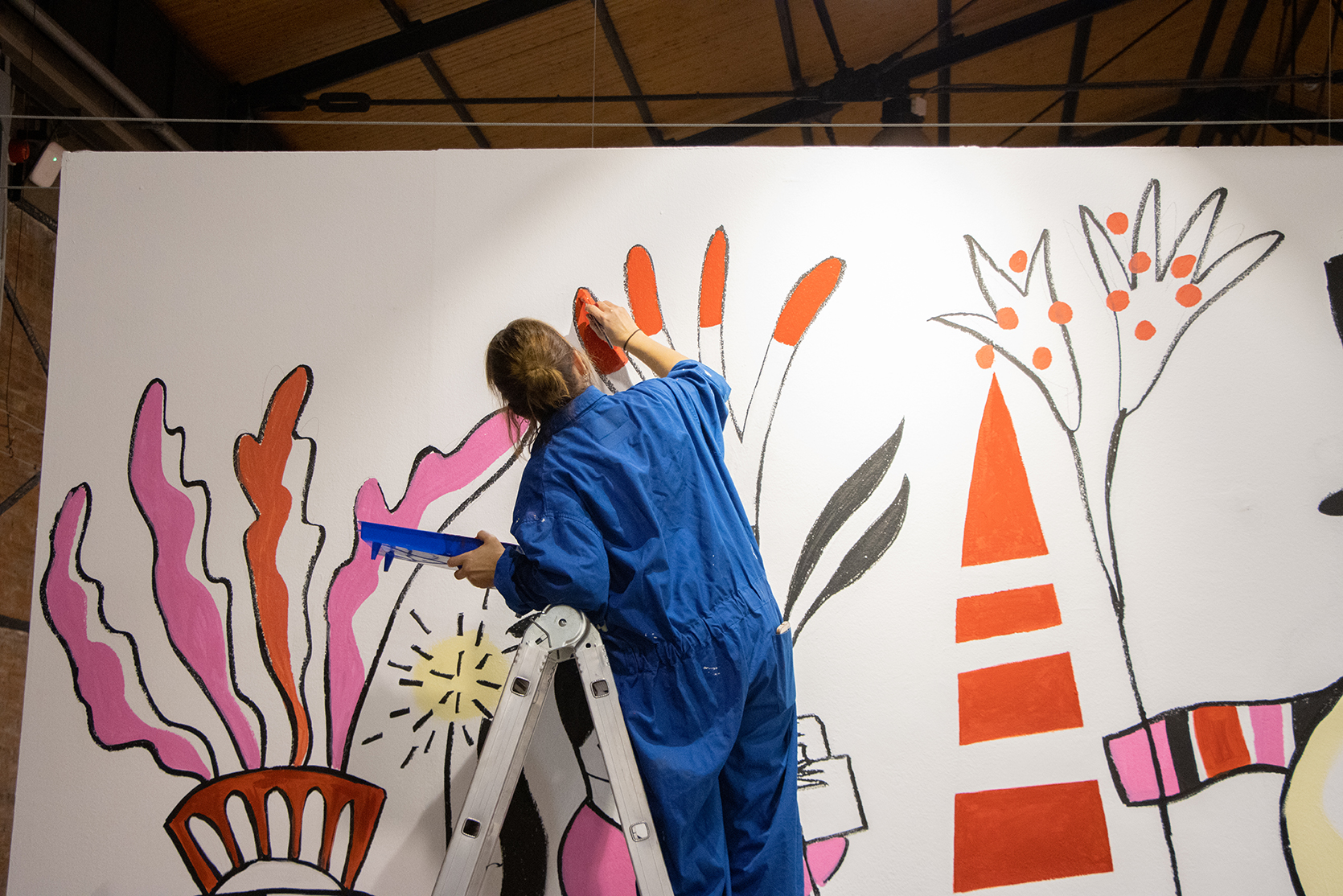 Students from EADTarragona assist artist Ignasi Blanch in creating the large mural 'Magical ...